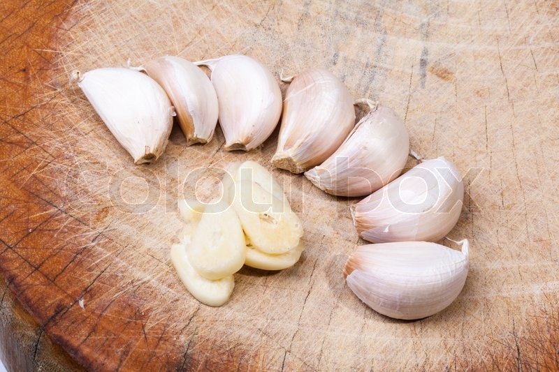 Peel of garlics sliced on wooden ... | Stock image | Colourbox