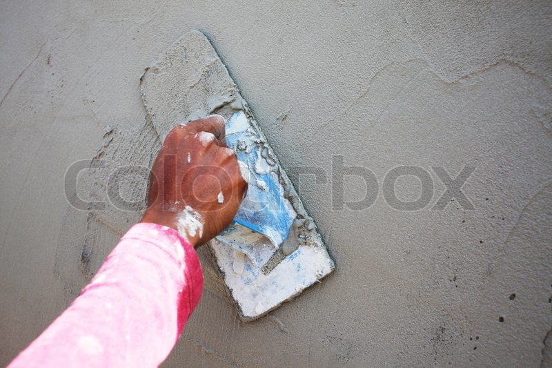 Man's hand plastering a wall with ... | Stock image | Colourbox