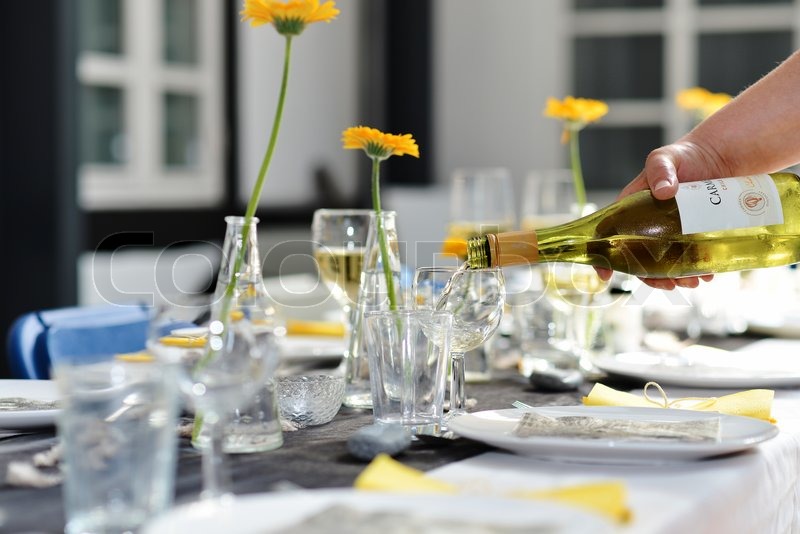 Serving white wine on buffet | Stock image | Colourbox