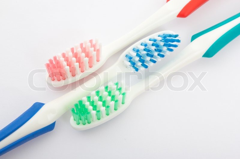 Red, green and blue toothbrush over ... | Stock image | Colourbox