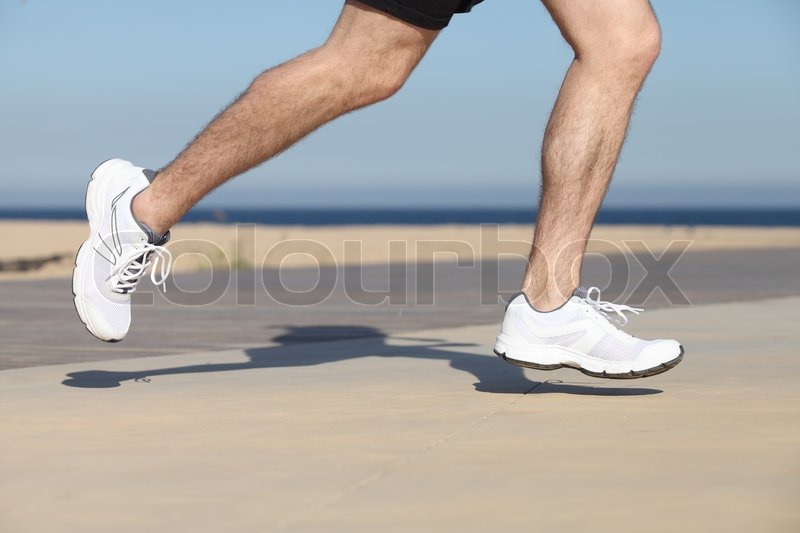 Side view of a man legs running on the ... | Stock image | Colourbox