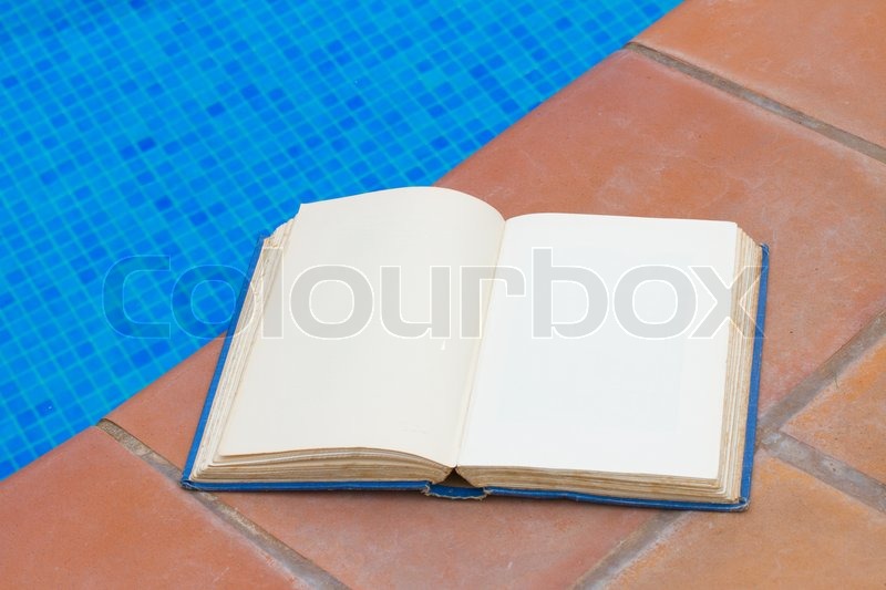 Summer reading open book at pool side | Stock image | Colourbox
