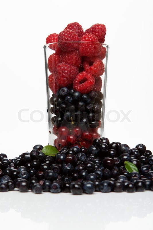 Glass cup with berries in a heap of ... | Stock image | Colourbox