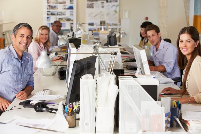 Team Working At Desks In Busy Office | Stock image | Colourbox