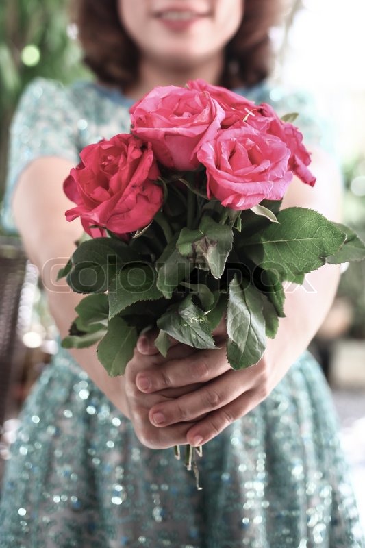 Woman hand and red rose | Stock image | Colourbox