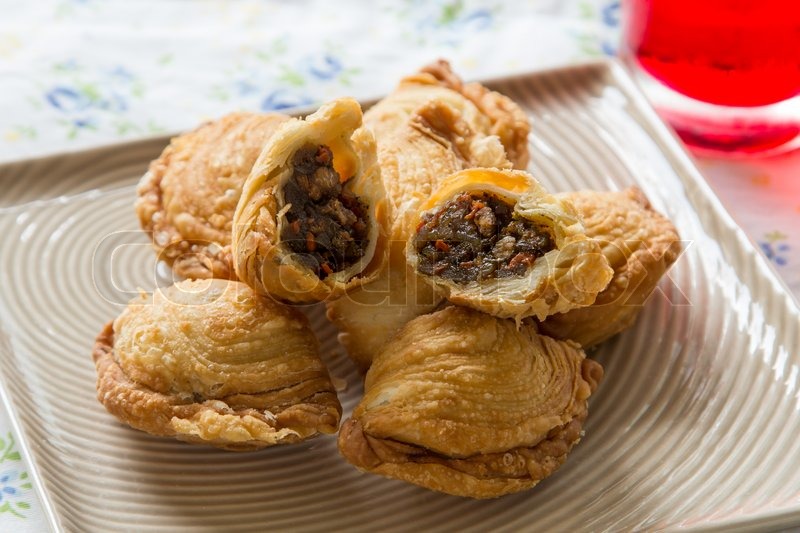 Pastry samosas in white dish appealing. | Stock image | Colourbox
