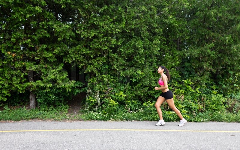 Fit woman running on the nature trail | Stock image | Colourbox