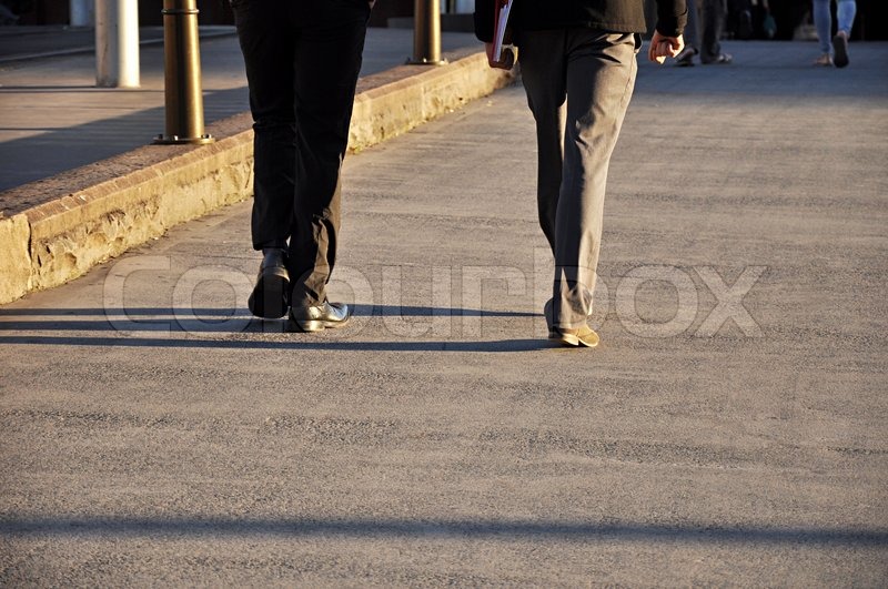 Two men walking on the pavement | Stock image | Colourbox