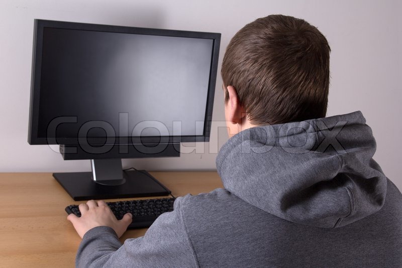 Young man using a personal computer at ... | Stock image | Colourbox