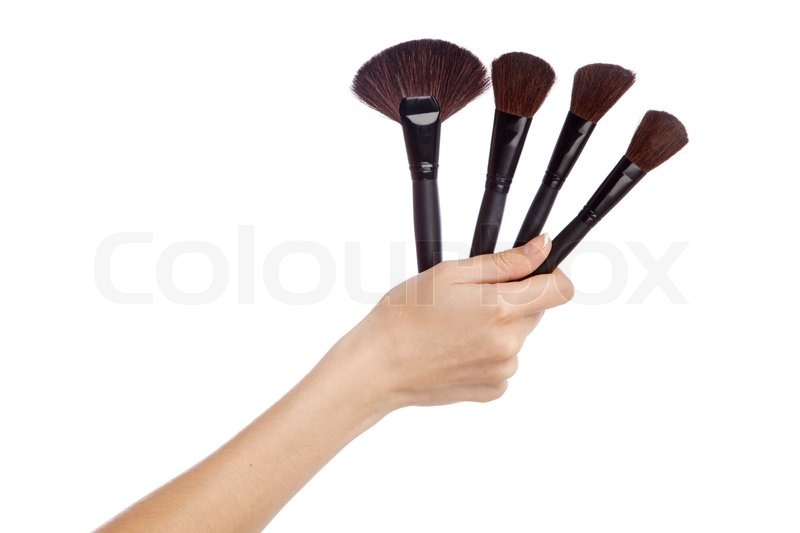 Female hand holding makeup brushes, ... | Stock image | Colourbox