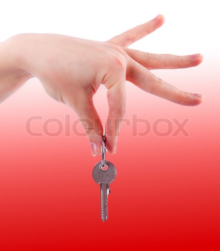 Silver key in a hand. Hand holding key | Stock image | Colourbox
