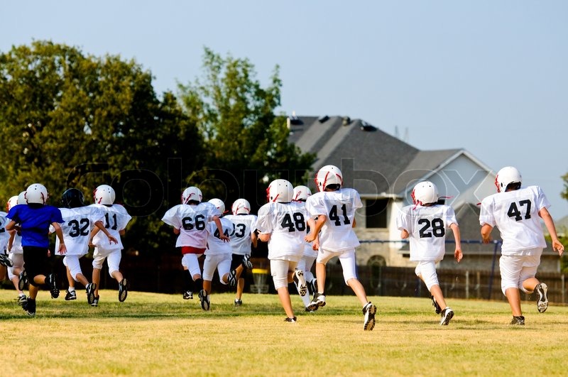 Teen football team running during ... | Stock image | Colourbox