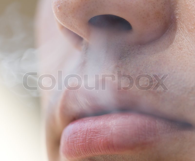 Cigarette smoke from the nose | Stock image | Colourbox