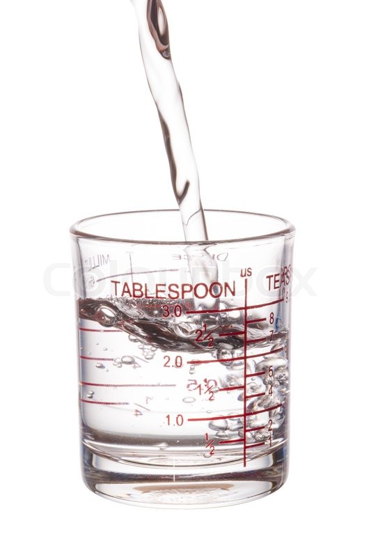 Pouring liquid to measuring glass | Stock image | Colourbox