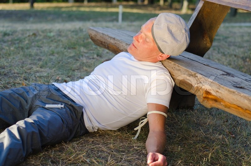 Drug addict collapsed on the ground ... | Stock image | Colourbox