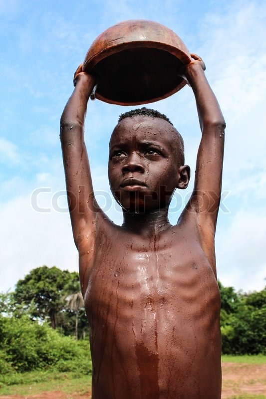 A kid taking a typical shower in the poor but rich Cañabaque, a ...
