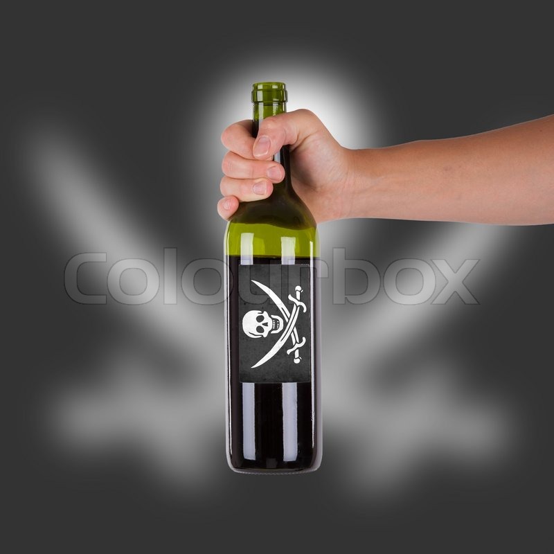 Hand holding a bottle of red wine, ... | Stock image | Colourbox