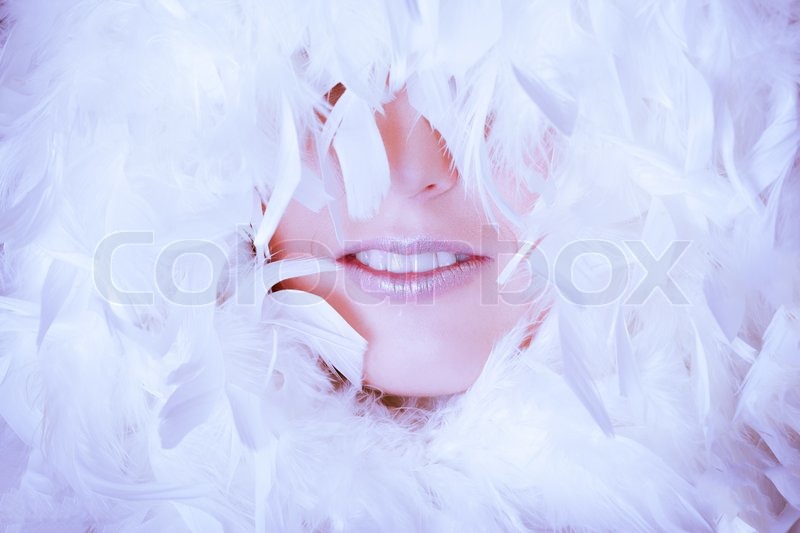 Beautiful woman with white feathers | Stock image | Colourbox