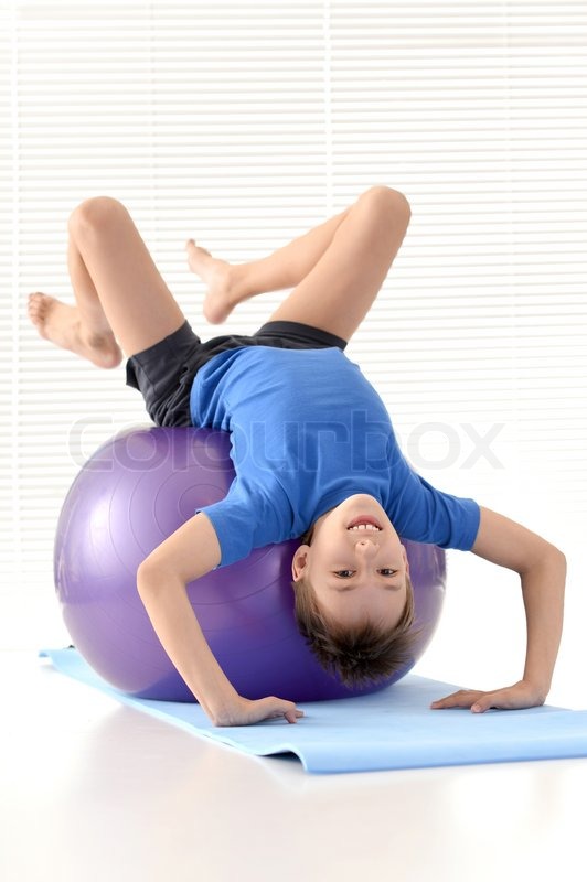 Sporty young boy in a blue shirt with ... | Stock image | Colourbox