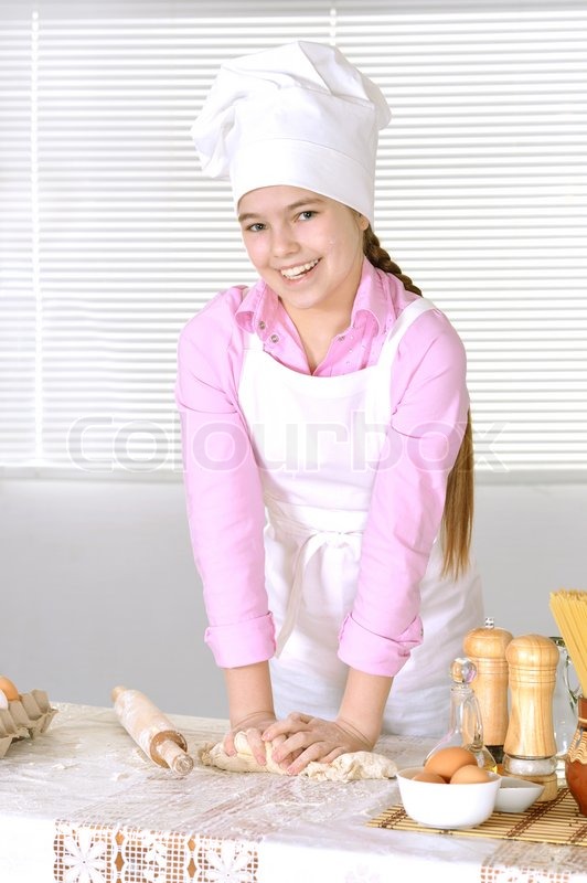 Cute girl baking cake in the kitchen at ... | Stock image | Colourbox