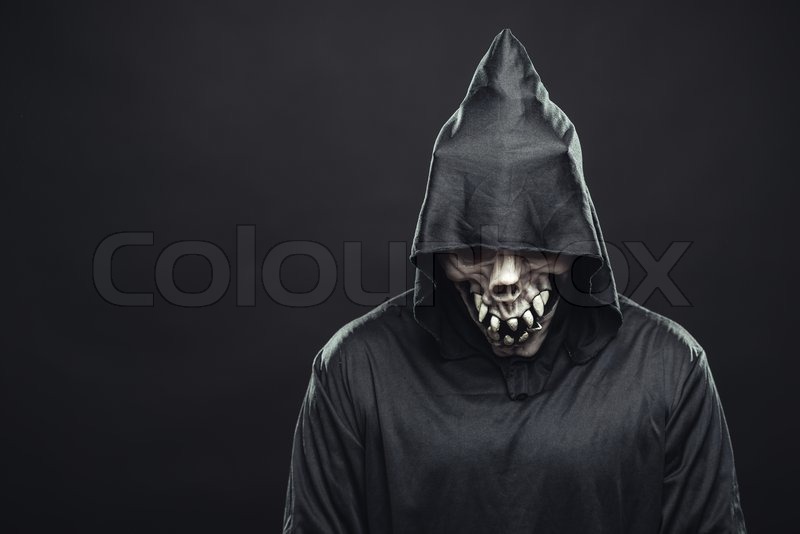 Skeleton in a black robe standing in ... | Stock image | Colourbox