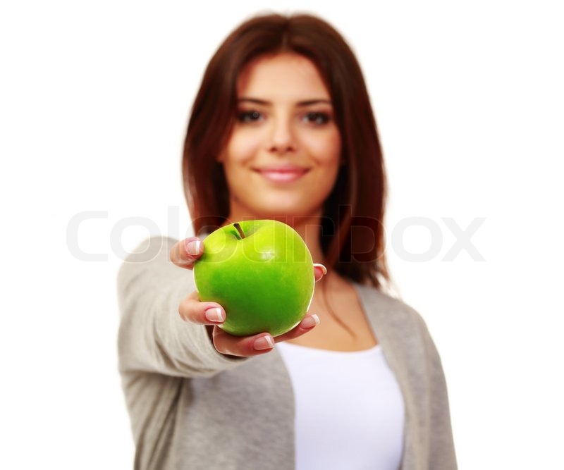 Young happy woman giving you an apple ... | Stock image | Colourbox