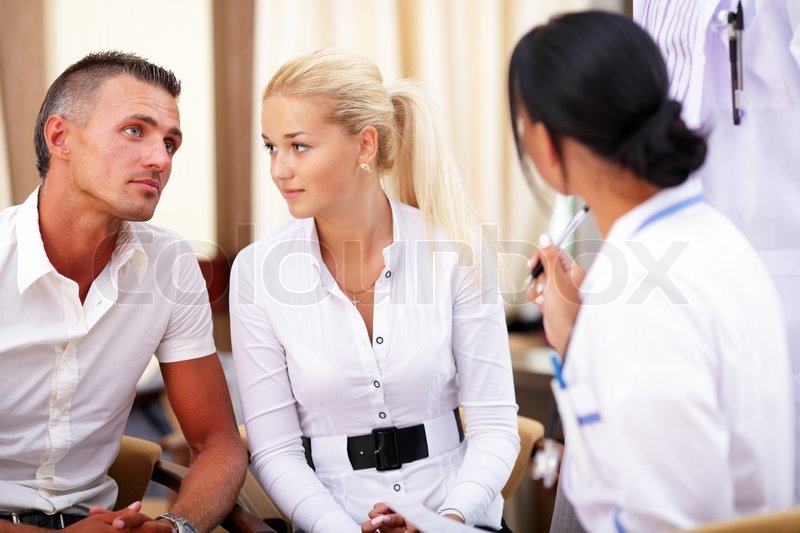 Medical doctor and young couple ... | Stock image | Colourbox