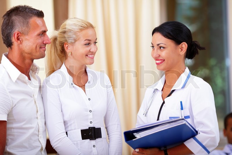 Medical doctor and young couple ... | Stock image | Colourbox