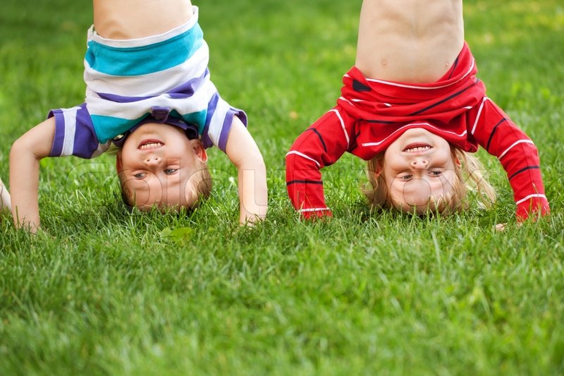 Happy little kids standing upside down ... | Stock image | Colourbox