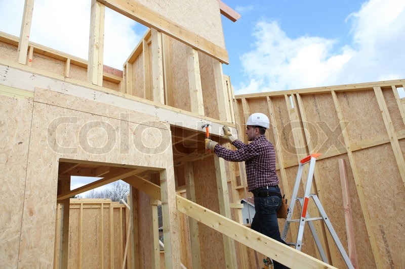Carpenter at work in construction site | Stock image | Colourbox