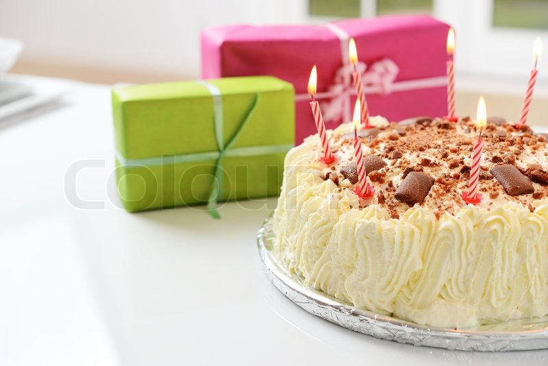 Birthday cake with lit candles and ... | Stock image | Colourbox