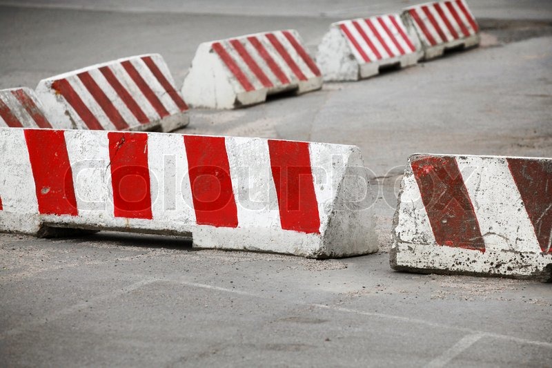 Red and white striped concrete road ... | Stock image | Colourbox