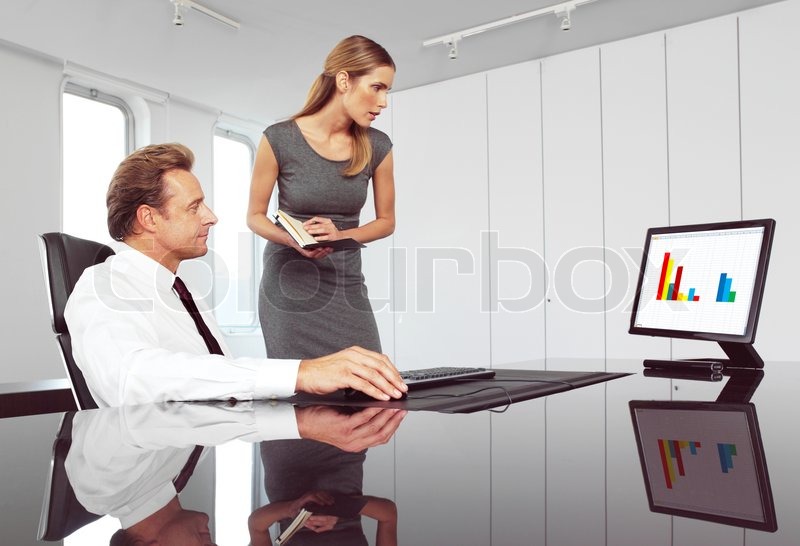 Boss helping secretary to type document ... | Stock image | Colourbox