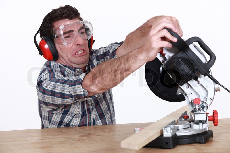Man struggling to use a mitre saw | Stock image | Colourbox