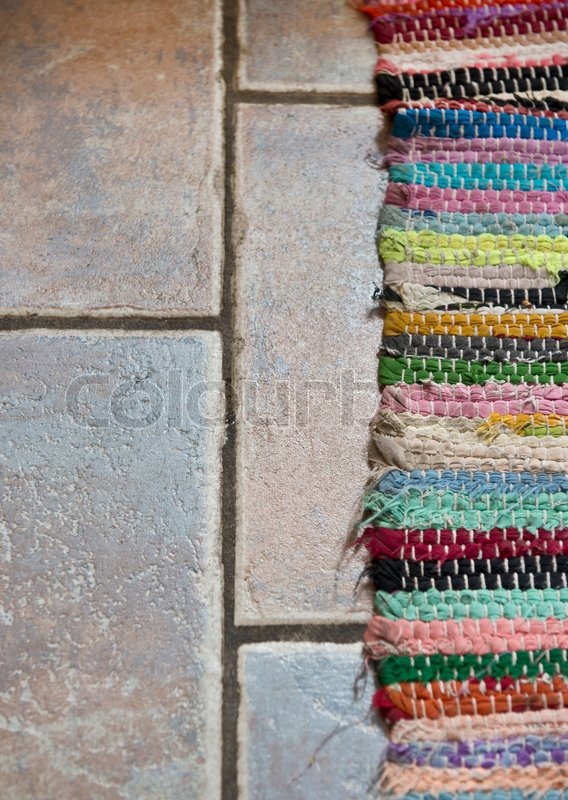 Closeup of a part of rag-rug and floor ... | Stock image | Colourbox