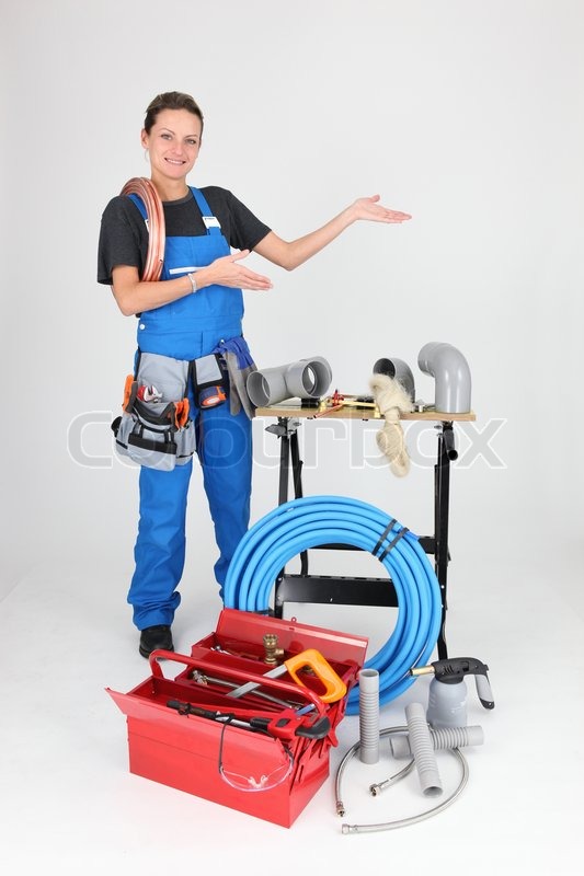 Woman plumber showing | Stock Photo | Colourbox