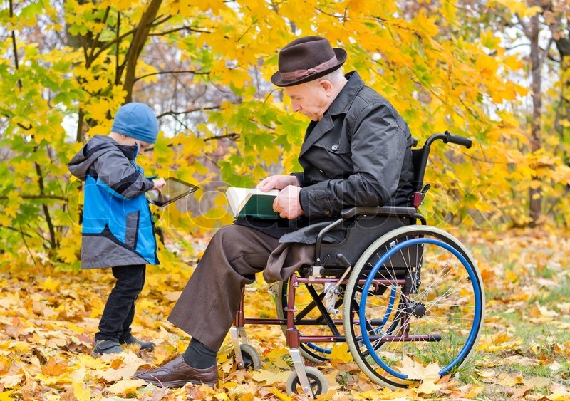 Elderly disabled man sitting reading a ... | Stock image | Colourbox