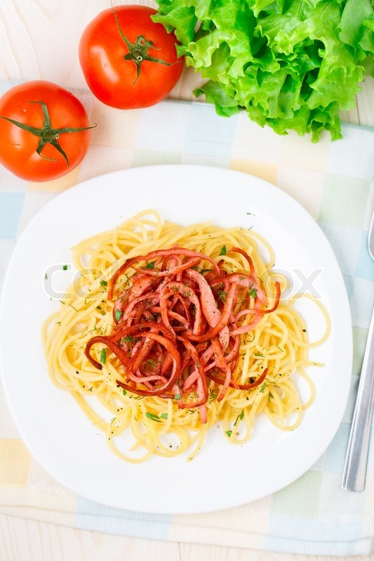 Spaghetti with fried ham on a plate | Stock image | Colourbox