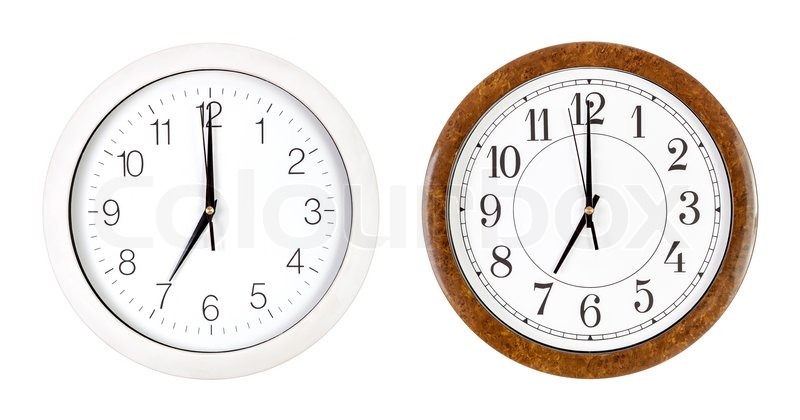 Two clock faces showing seven o'clock ... | Stock image | Colourbox