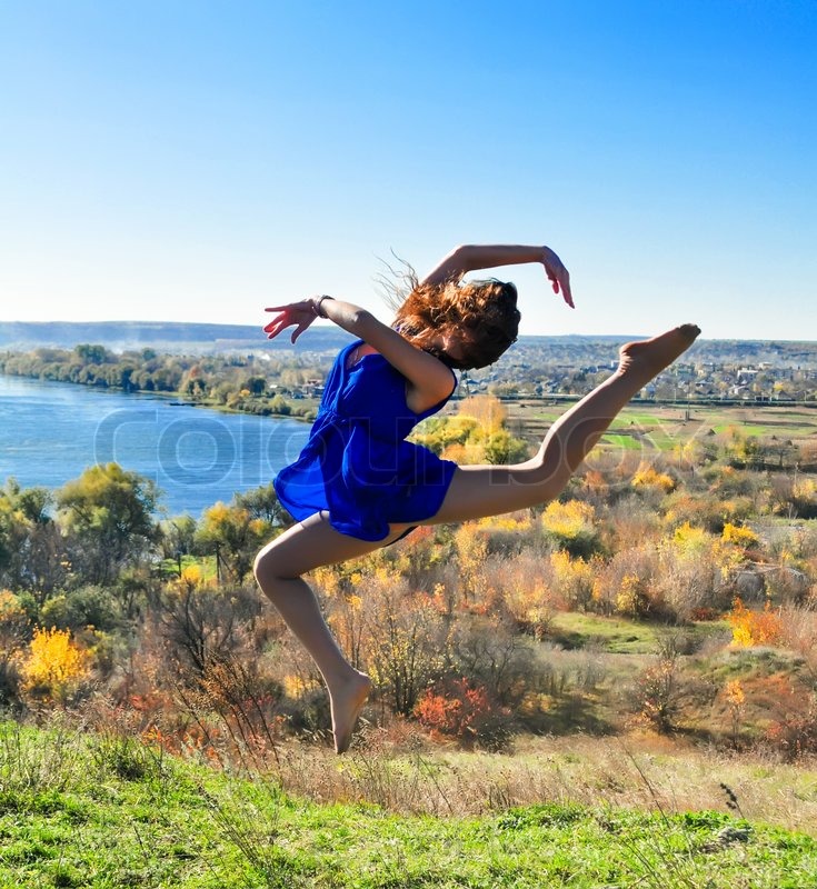 Girl jumping on a background of autumn ... | Stock image | Colourbox