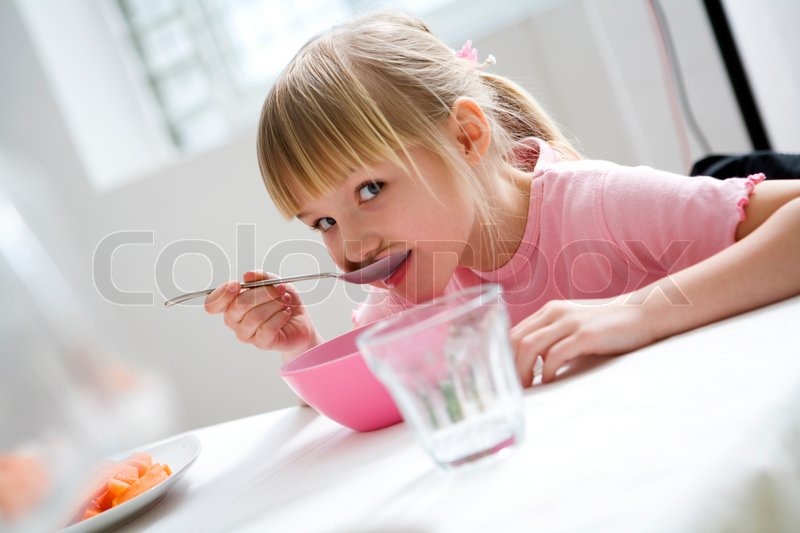 A caucasian girl eating her healthy ... | Stock image | Colourbox
