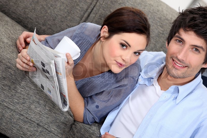 Couple reading a newspaper at home | Stock image | Colourbox