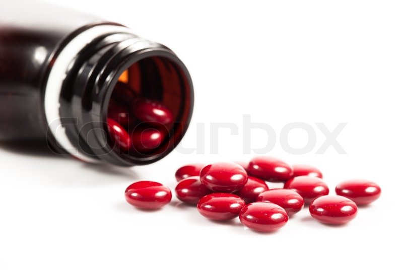 Red pills and pill bottle on white | Stock image | Colourbox