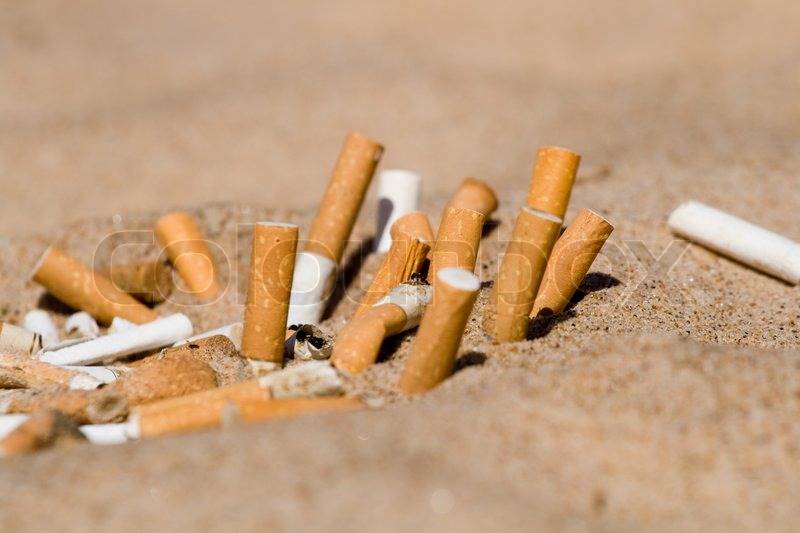 Cigarette butt in sand | Stock Photo | Colourbox
