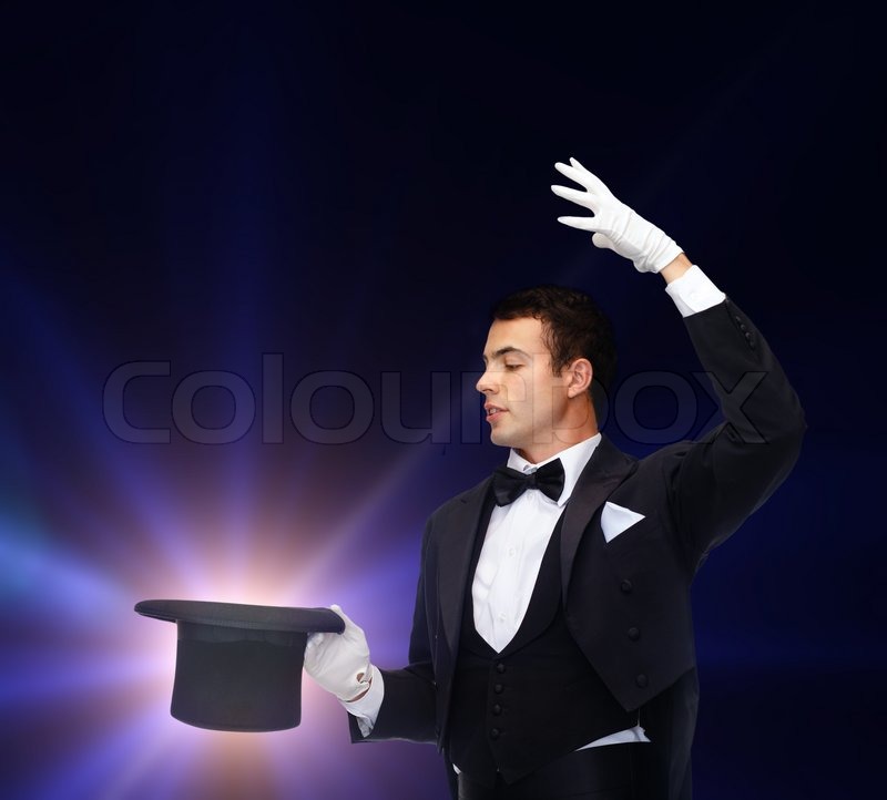 Magician in top hat showing trick | Stock Photo | Colourbox
