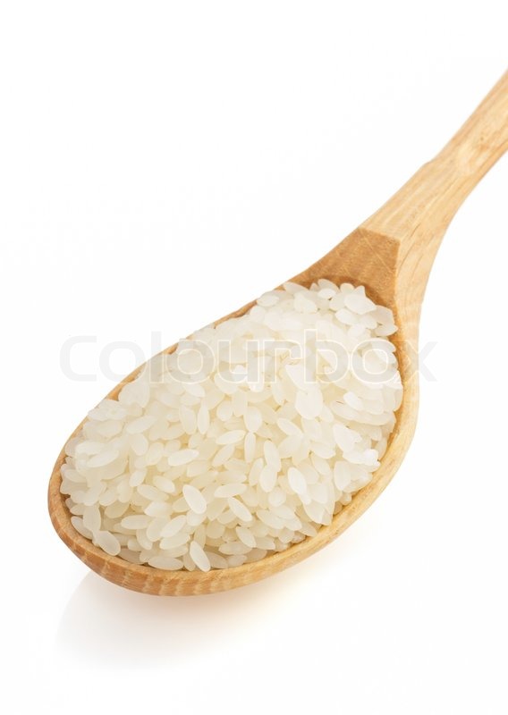 Uncooked rice in wooden spoon isolated ... | Stock image | Colourbox
