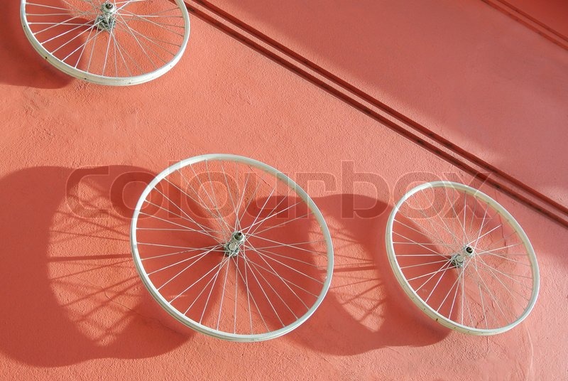 Three bicycle wheels mounted on the ... | Stock image | Colourbox