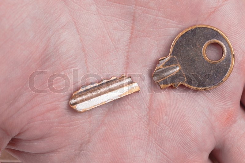 Broken key with hand closeup | Stock image | Colourbox