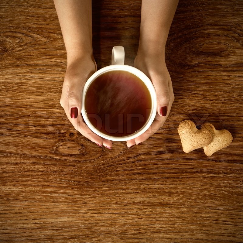 Woman holding hot cup of tea with ... | Stock image | Colourbox