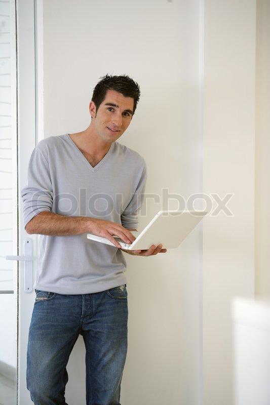 Man stood with portable computer | Stock image | Colourbox
